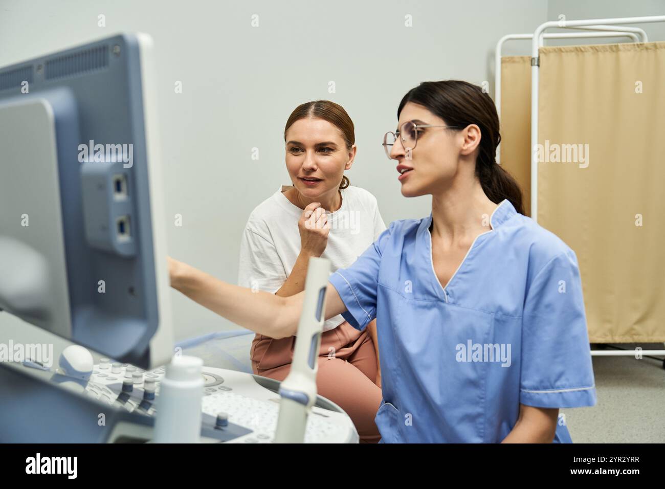 A gynecologist explains diagnostic results to a female patient in a ...