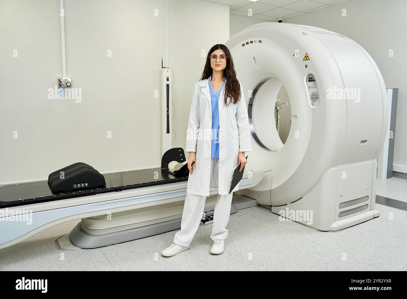 Attractive female doctor in a lab coat is readying for patient ...
