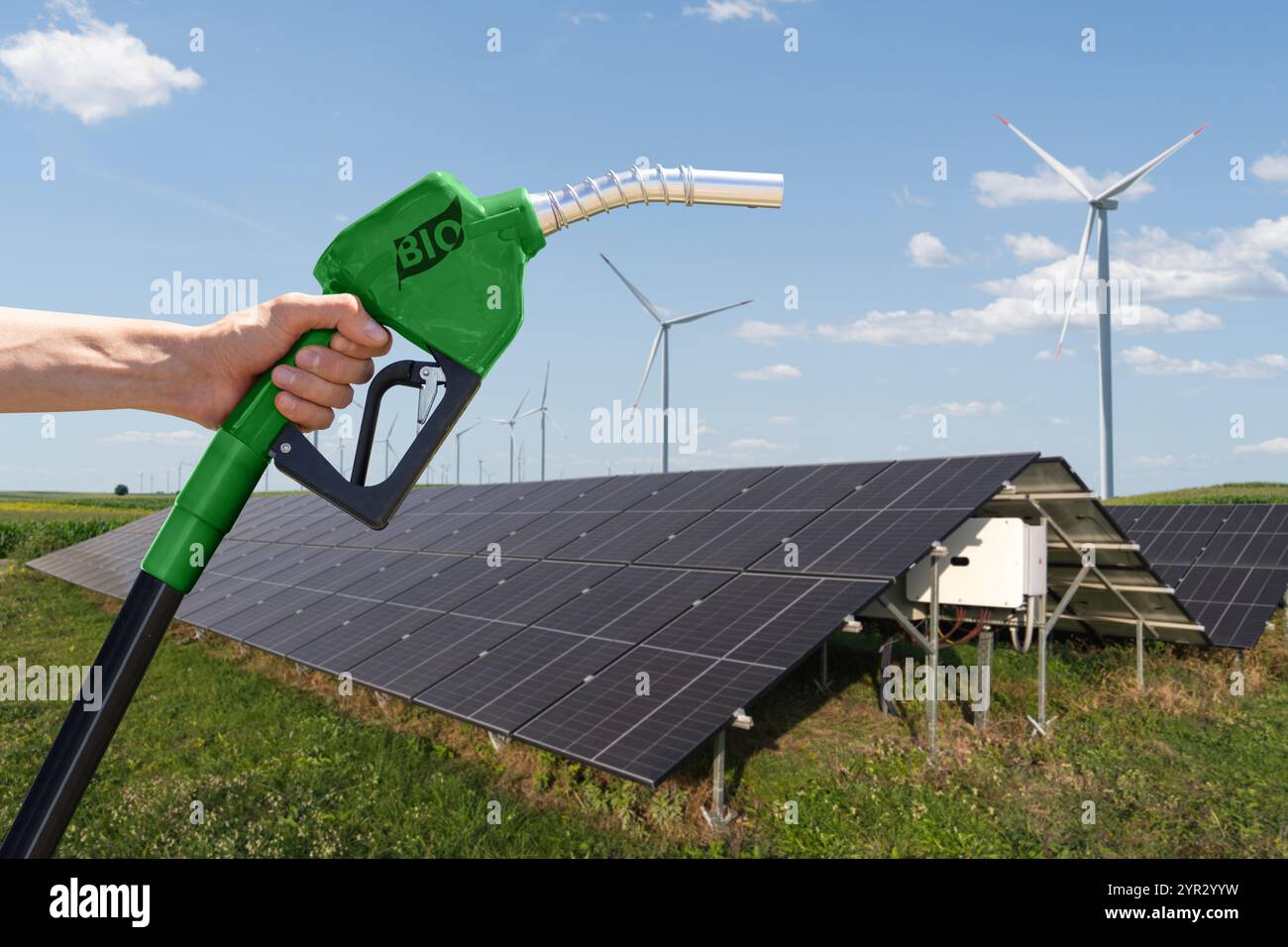 Hand with biofuel refueling nozzle on a background of solar panels ...