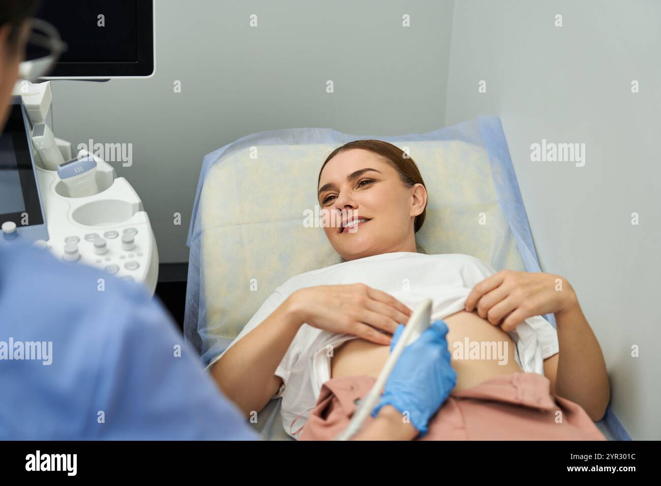A skilled gynecologist conducts a patient examination focused on ...