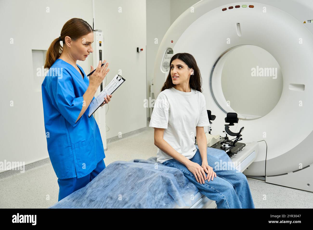 Female doctor provides guidance to patient before MRI scan in hospital ...