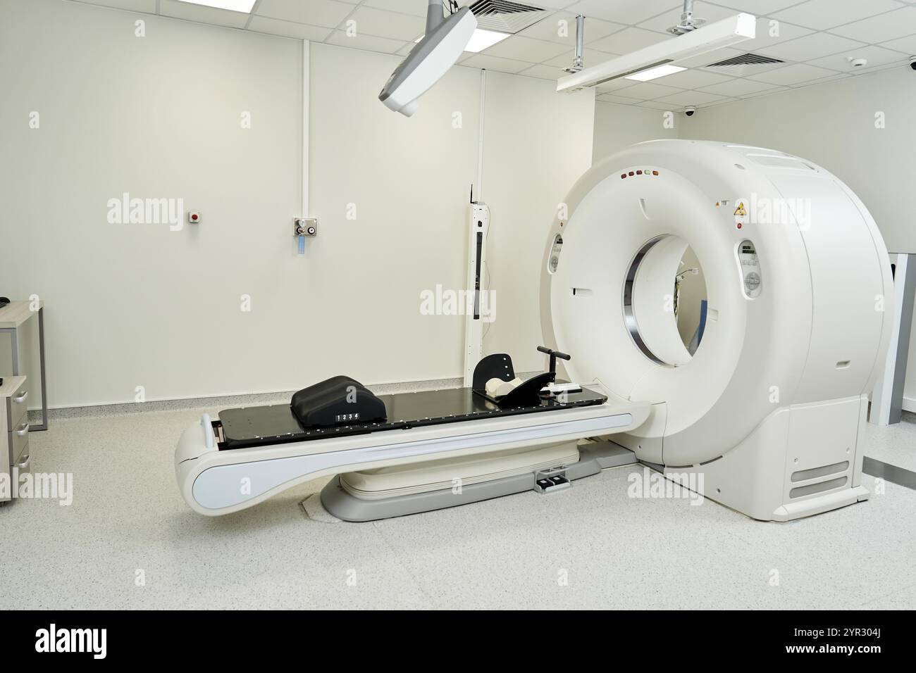 Cutting-edge MRI machine in a spacious hospital radiology room designed ...