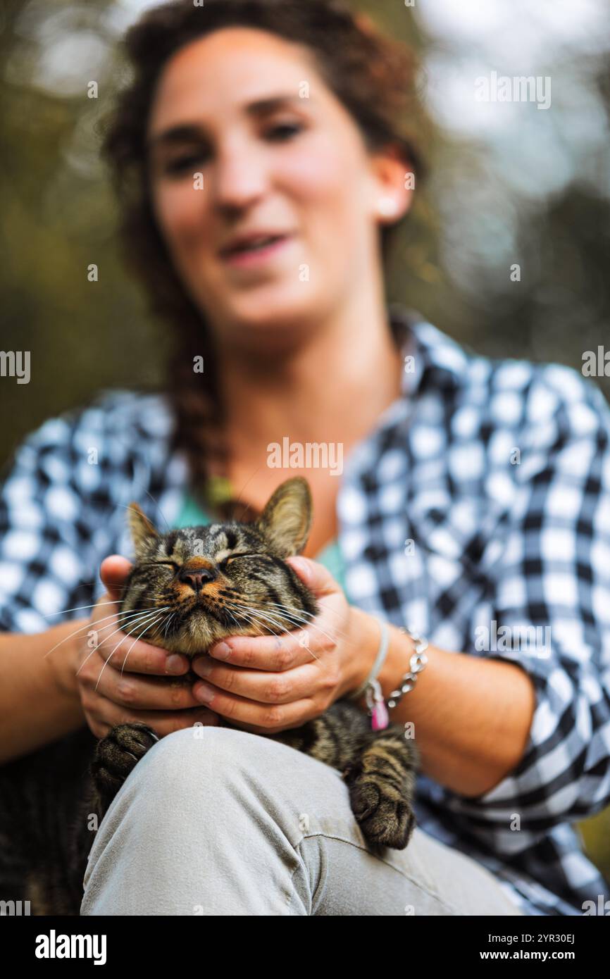 Young woman gently holds pets hi-res stock photography and images - Alamy