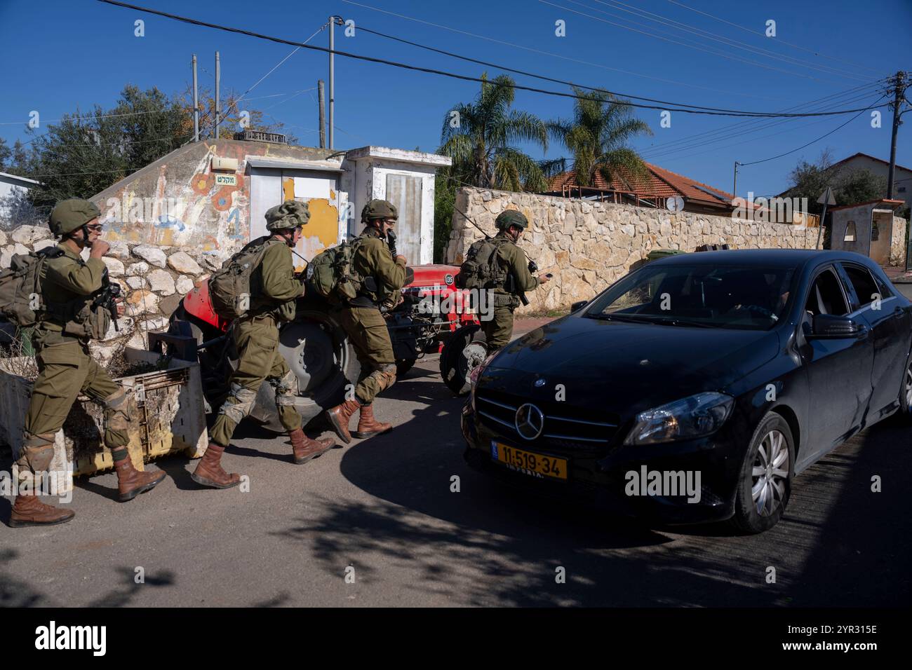 Israeli soldiers patrol the perimeter of the agricultural settlement of ...