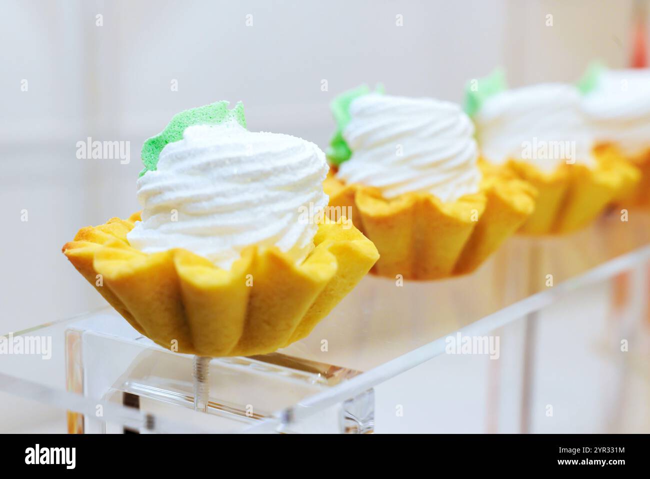 Brightly colored dessert cups are arranged in bakery case each cup ...