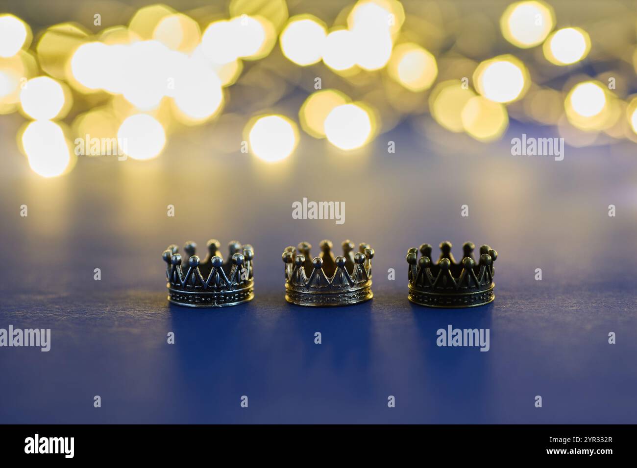 three shiny crowns and a lights on blue background. Epiphany and three ...
