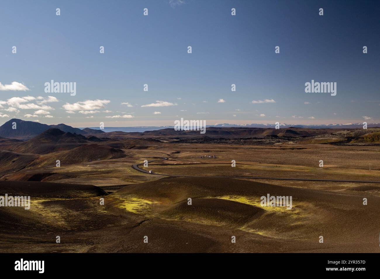 A breathtaking Icelandic landscape with towering mountains, fields, and ...