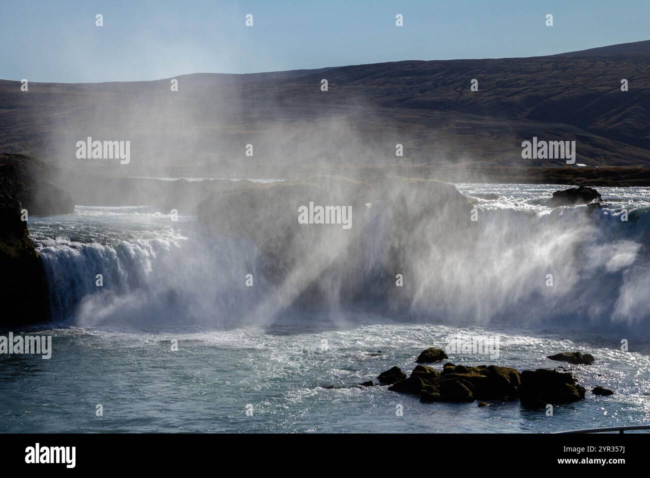 A stunning Icelandic waterfall cascading down rugged cliffs into a ...