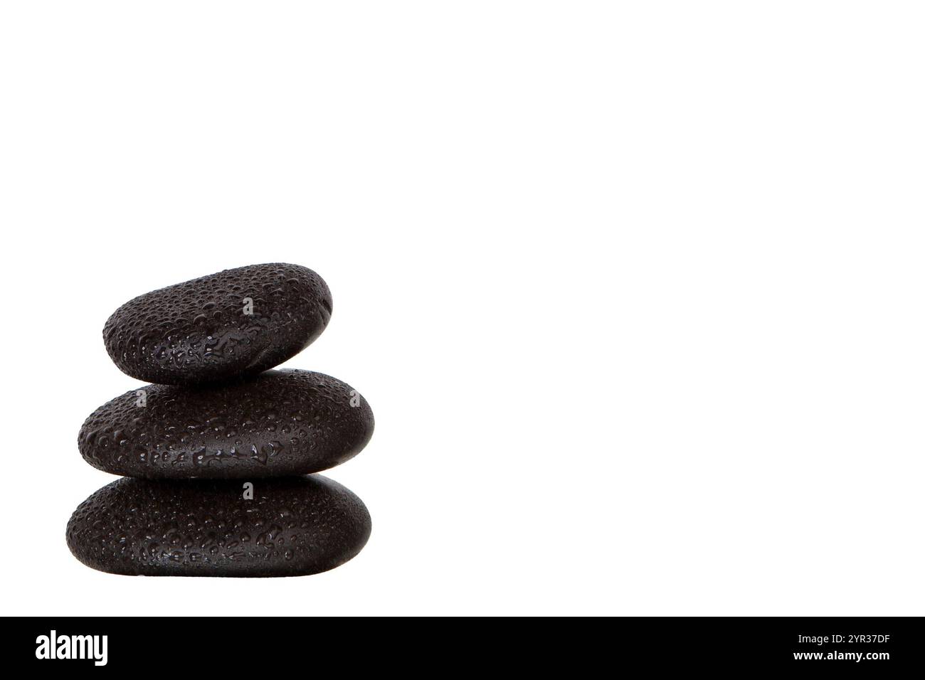 Stack of wet black spa stones Stock Photo - Alamy