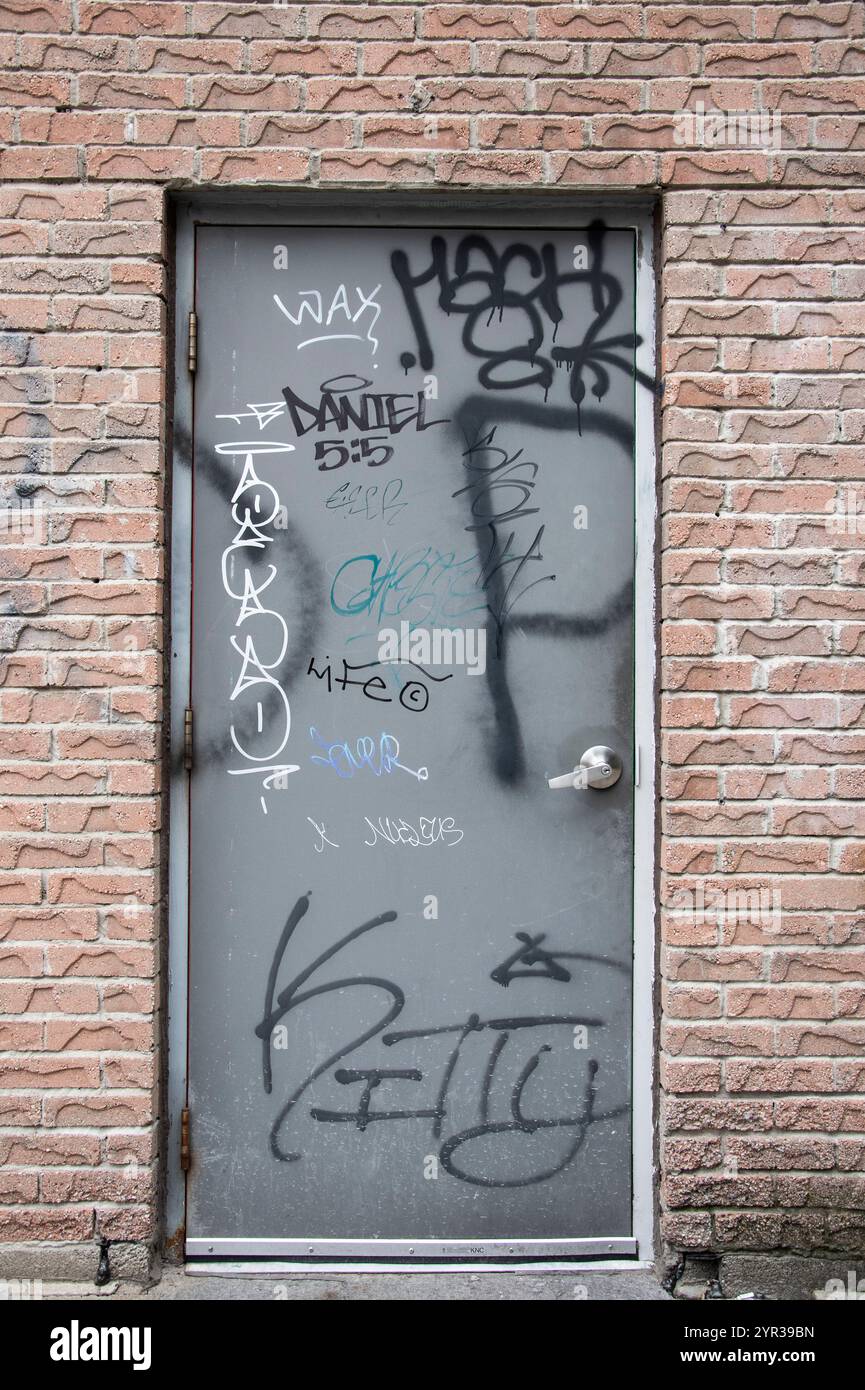 Graffiti tagged on a door near McCaul Street in downtown Toronto ...