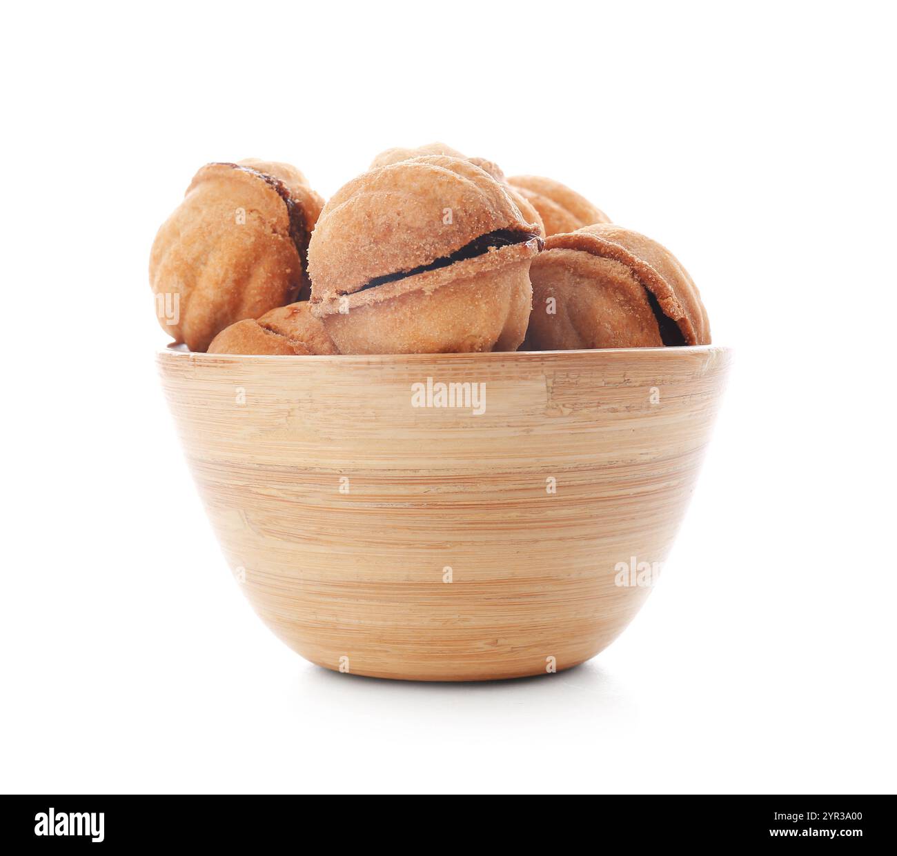 Bowl of sweet walnut shaped cookies with boiled condensed milk on white ...