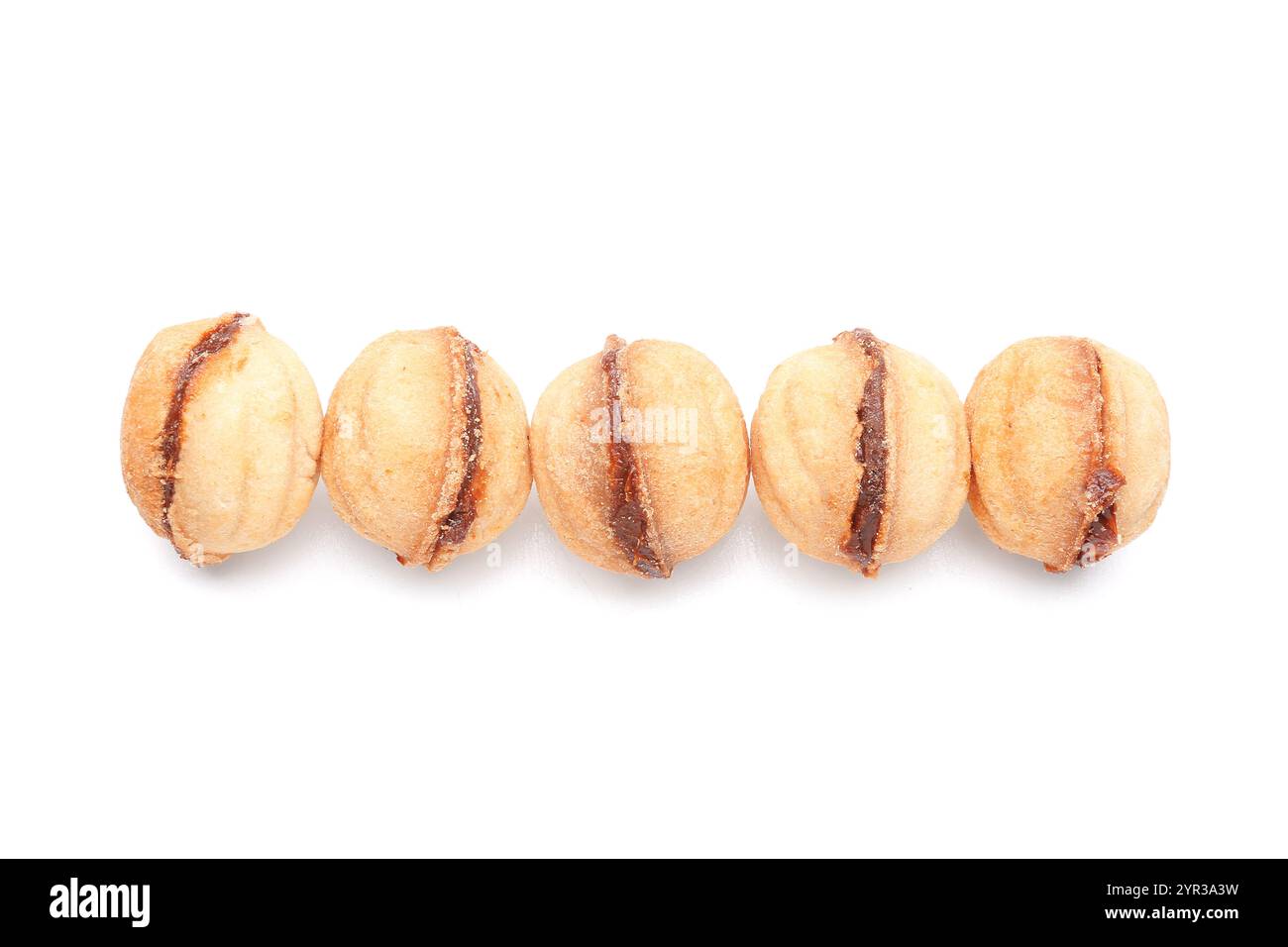 Many sweet walnut shaped cookies with boiled condensed milk on white ...
