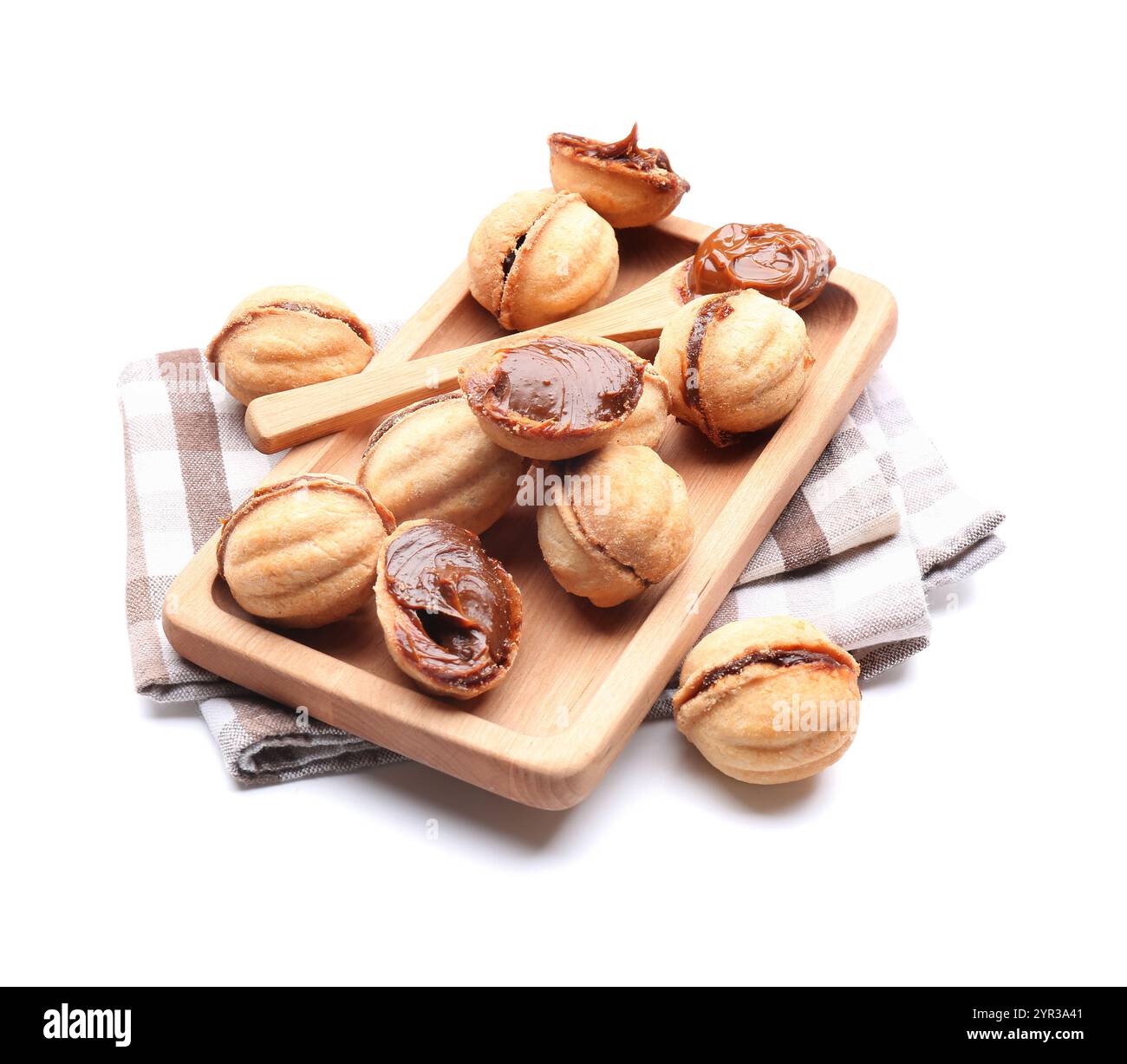 Wooden board of sweet walnut shaped cookies with boiled condensed milk ...