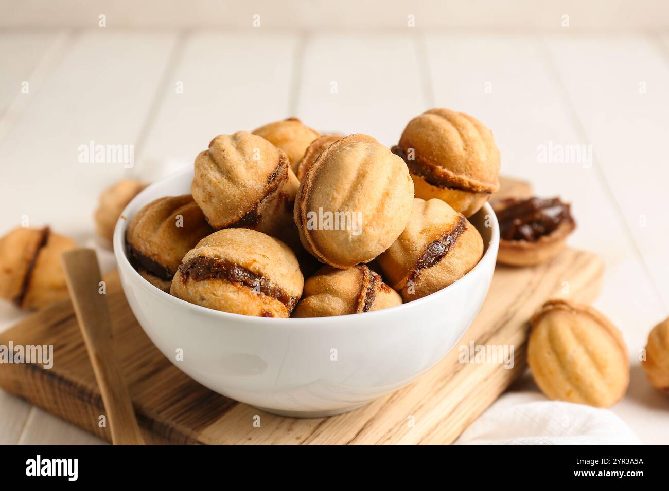 Bowl with sweet walnut shaped cookies with boiled condensed milk on ...