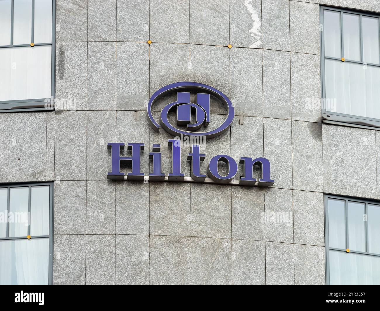 Hilton logo sign on the hotel building wall. American multinational ...