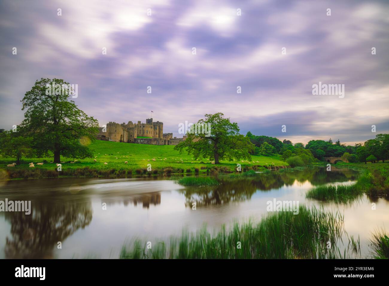 A picturesque view of a historic castle surrounded by lush green fields ...