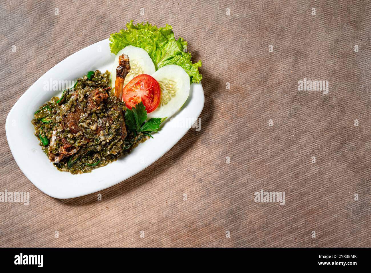 Bebek goreng cabe ijo or fried duck with green chili sauce. Traditional ...