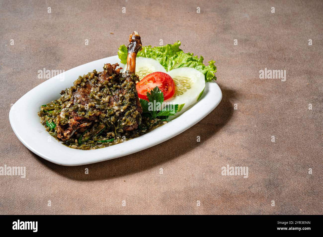 Bebek goreng cabe ijo or fried duck with green chili sauce. Traditional ...