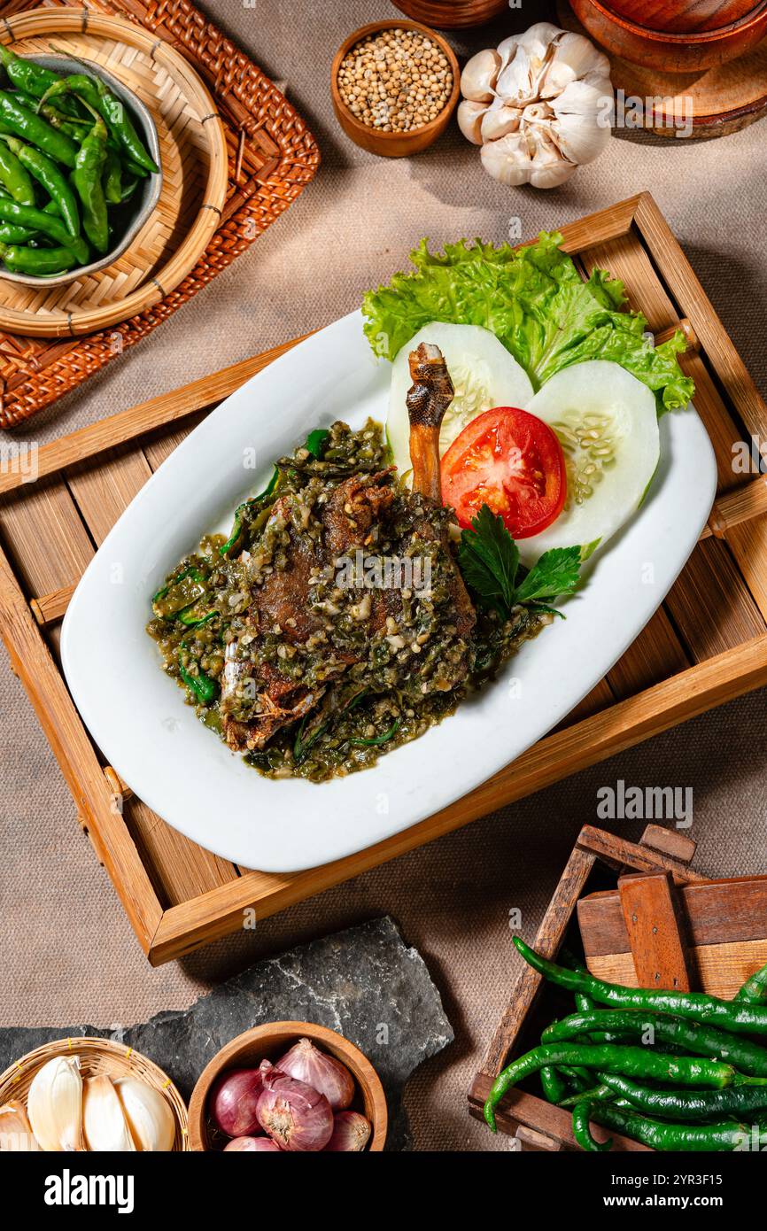 Bebek goreng cabe ijo or fried duck with green chili sauce. Traditional ...