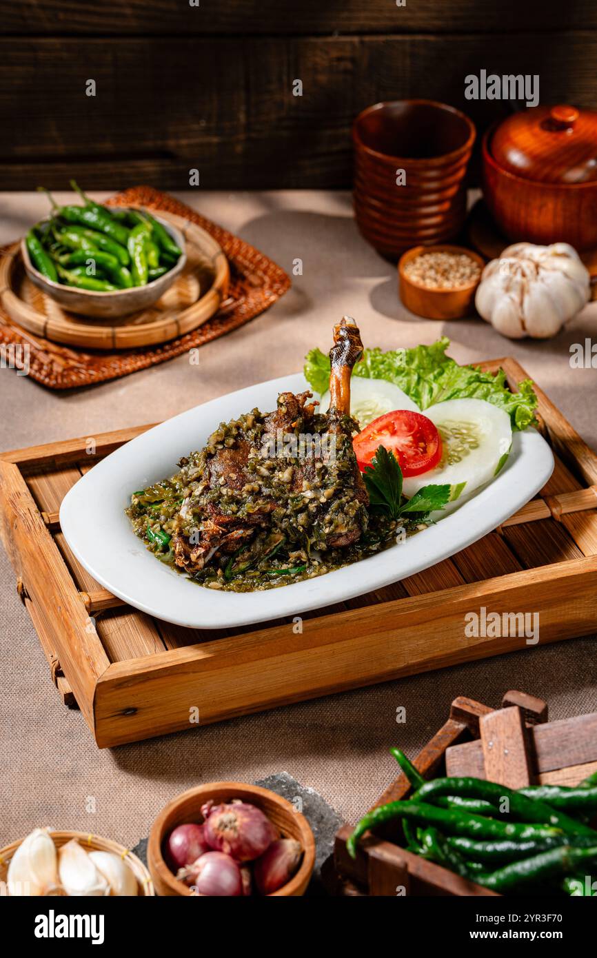 Bebek goreng cabe ijo or fried duck with green chili sauce. Traditional ...