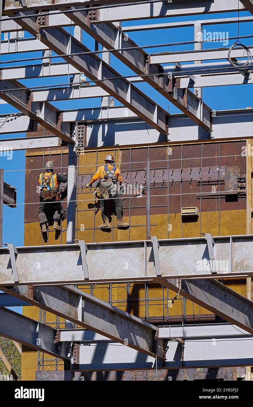 Ironworkers install metal decking at the future site of Ivanho ...