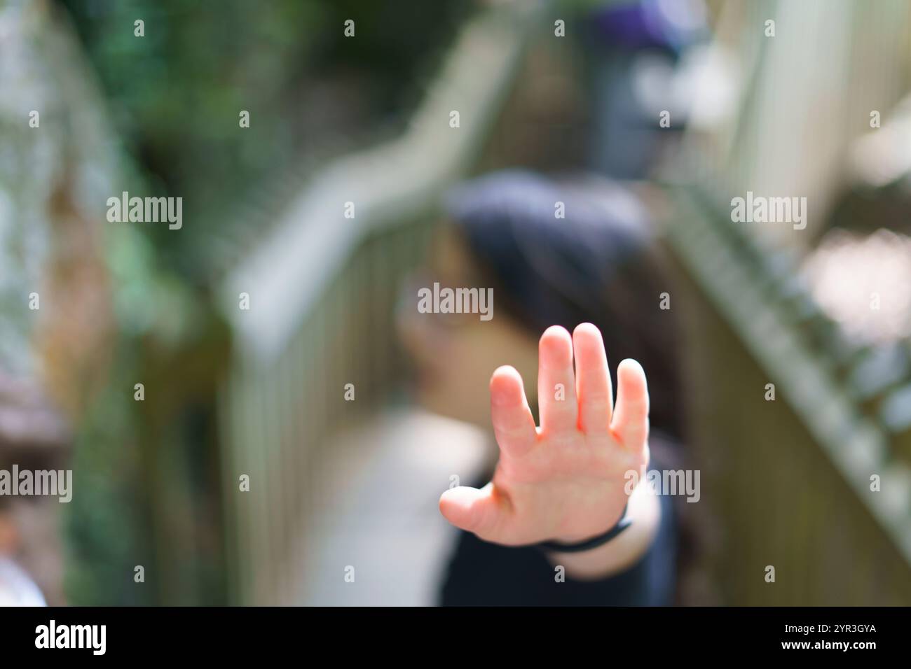 Little girl shows hand sign in summer outdoors Stock Photo - Alamy