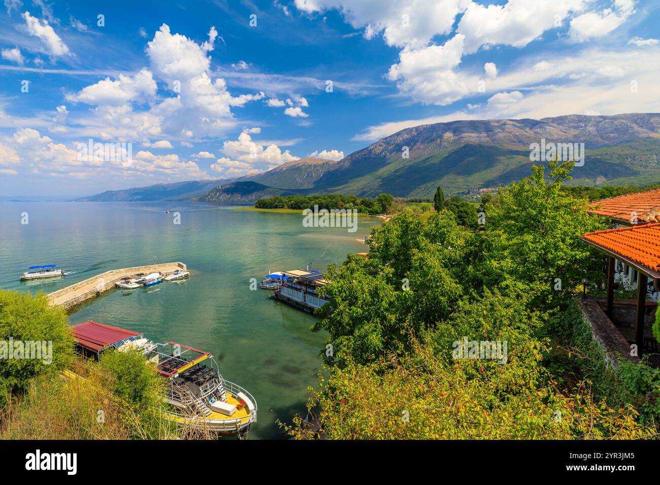 Lake Ohrid's crystal clear waters sparkle under a vibrant blue sky ...