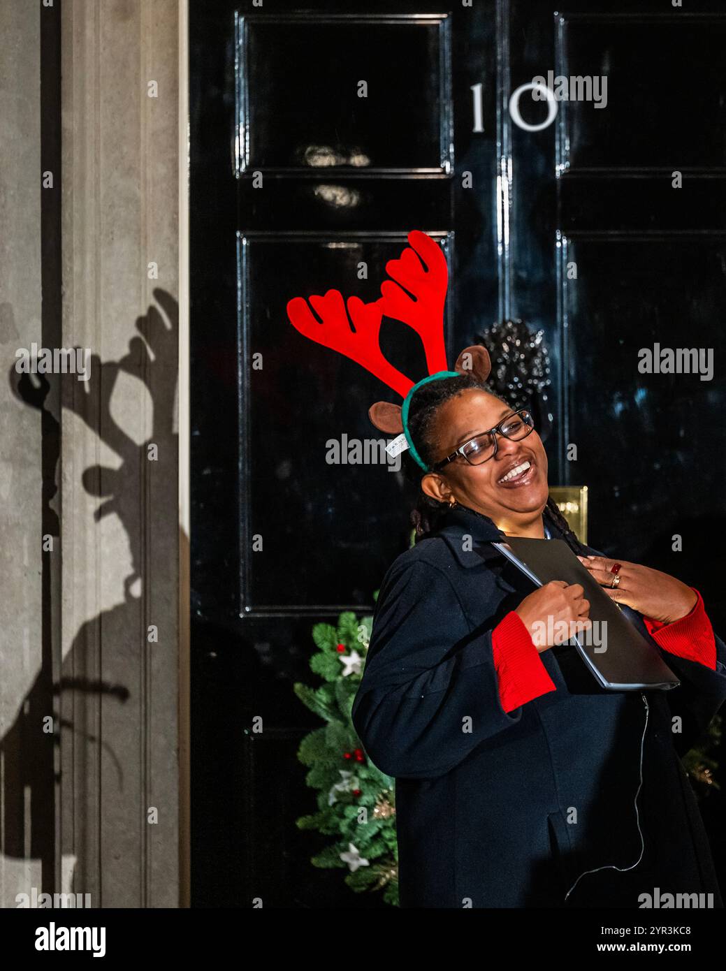 London, UK. 2 Dec 2024. One of the choir, in rheindeer horns, gets a ...