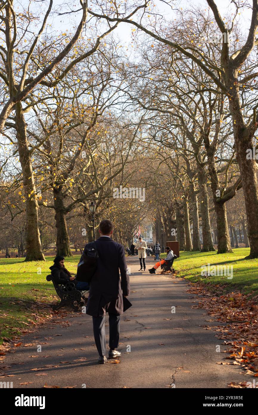 People on path across Green Park in St James London in autumn sunshine ...