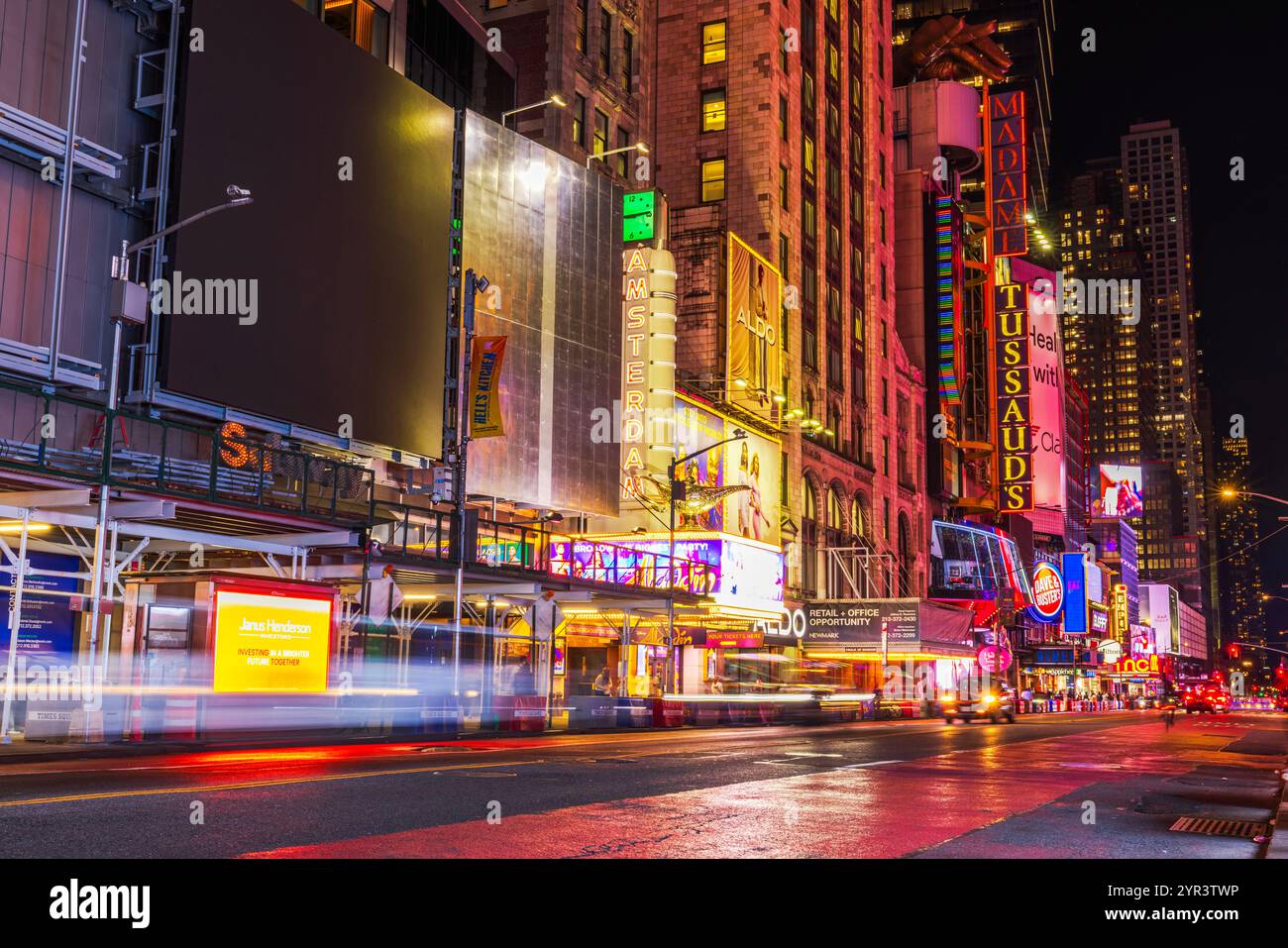 Times Square at night with illuminated signs, Madame Tussauds museum ...
