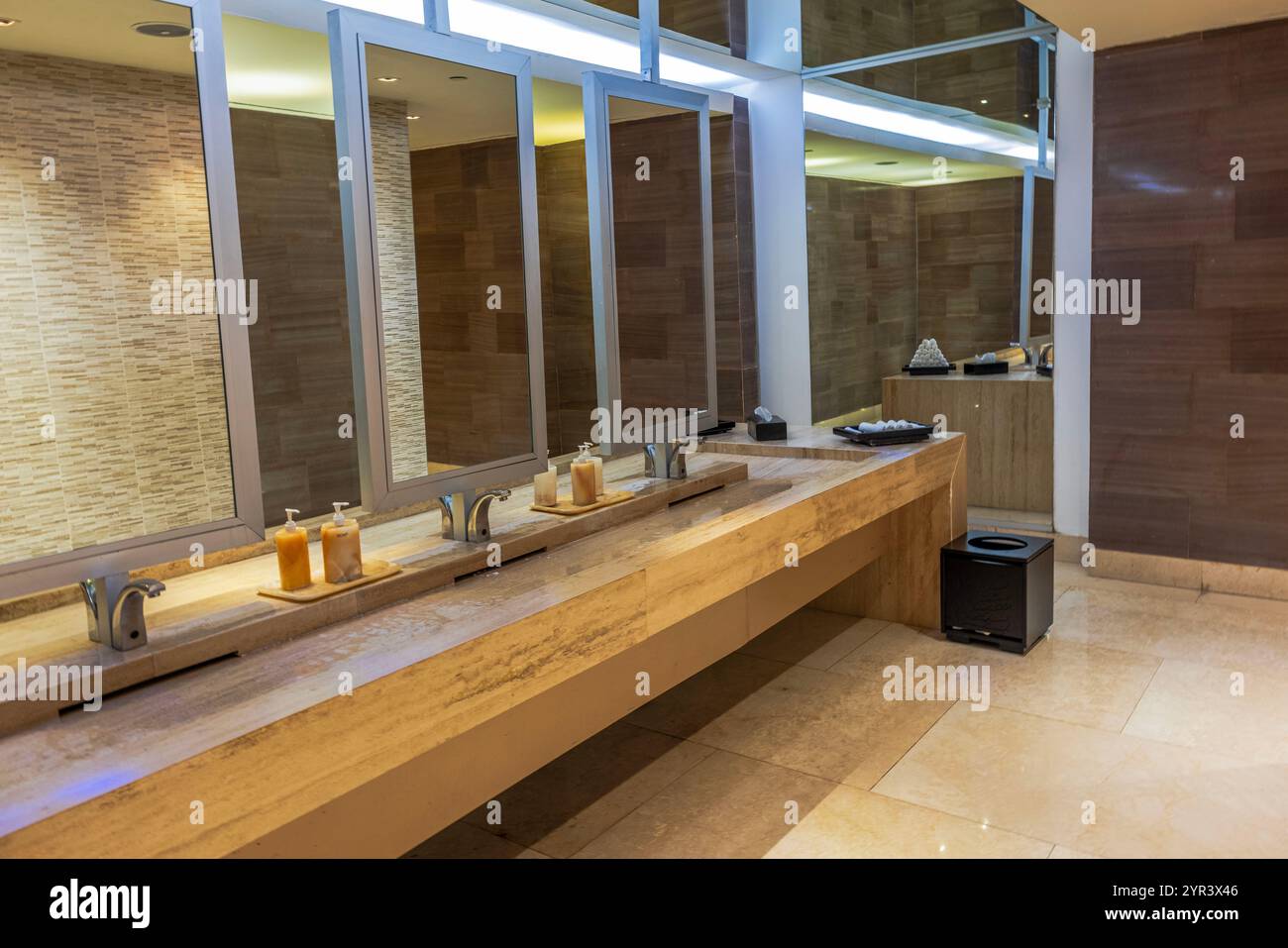 Modern restroom interior featuring sleek marble countertop with ...