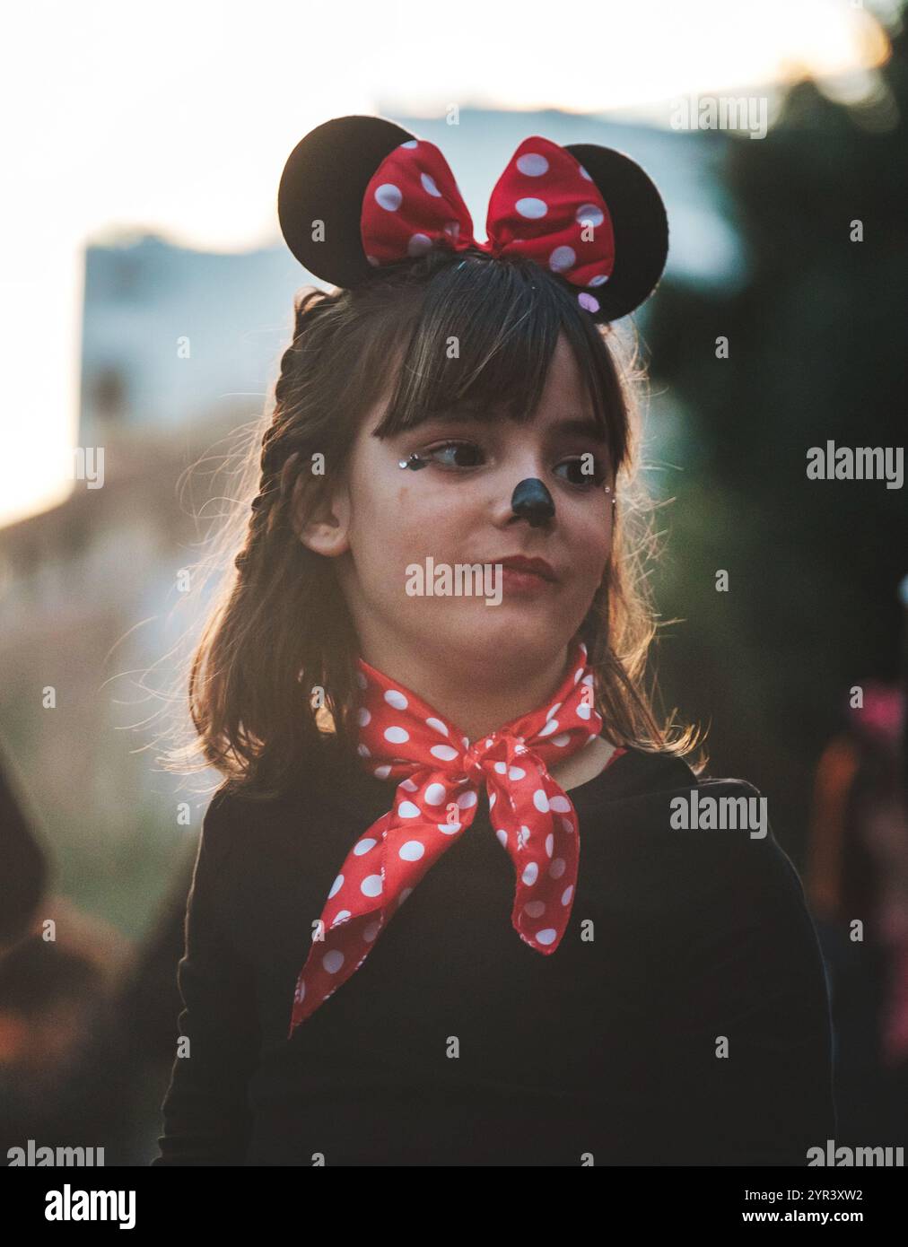 The image shows a child dressed in a costume that includes what looks ...