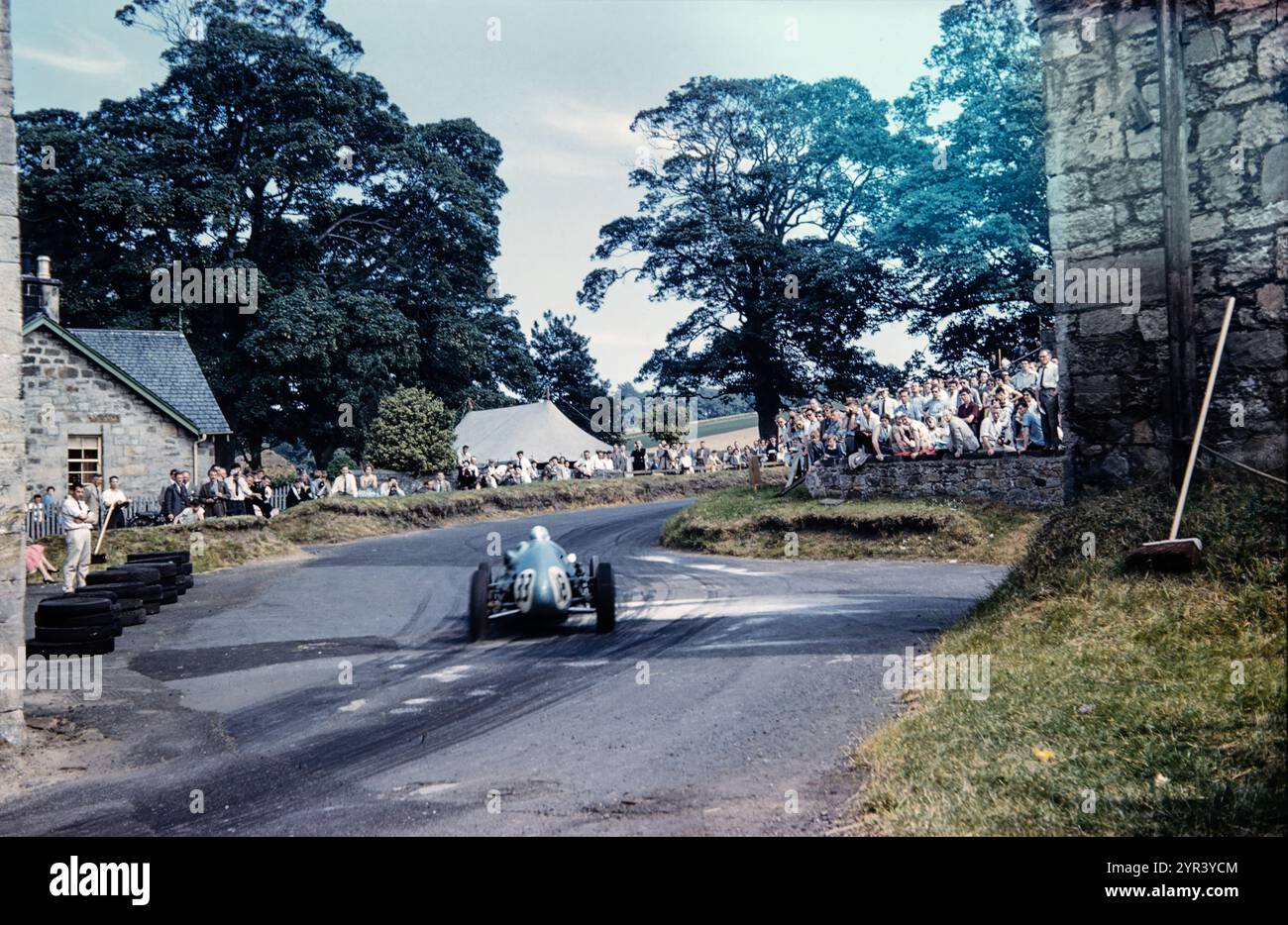 Historical photo of a crowd of people wathcing a race with and old ...