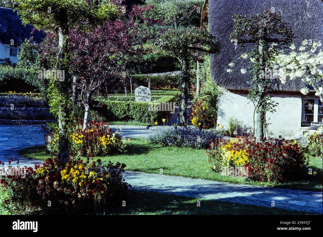 Historical photo of thatched cottage and sign to Ye Olde Wishing Well ...