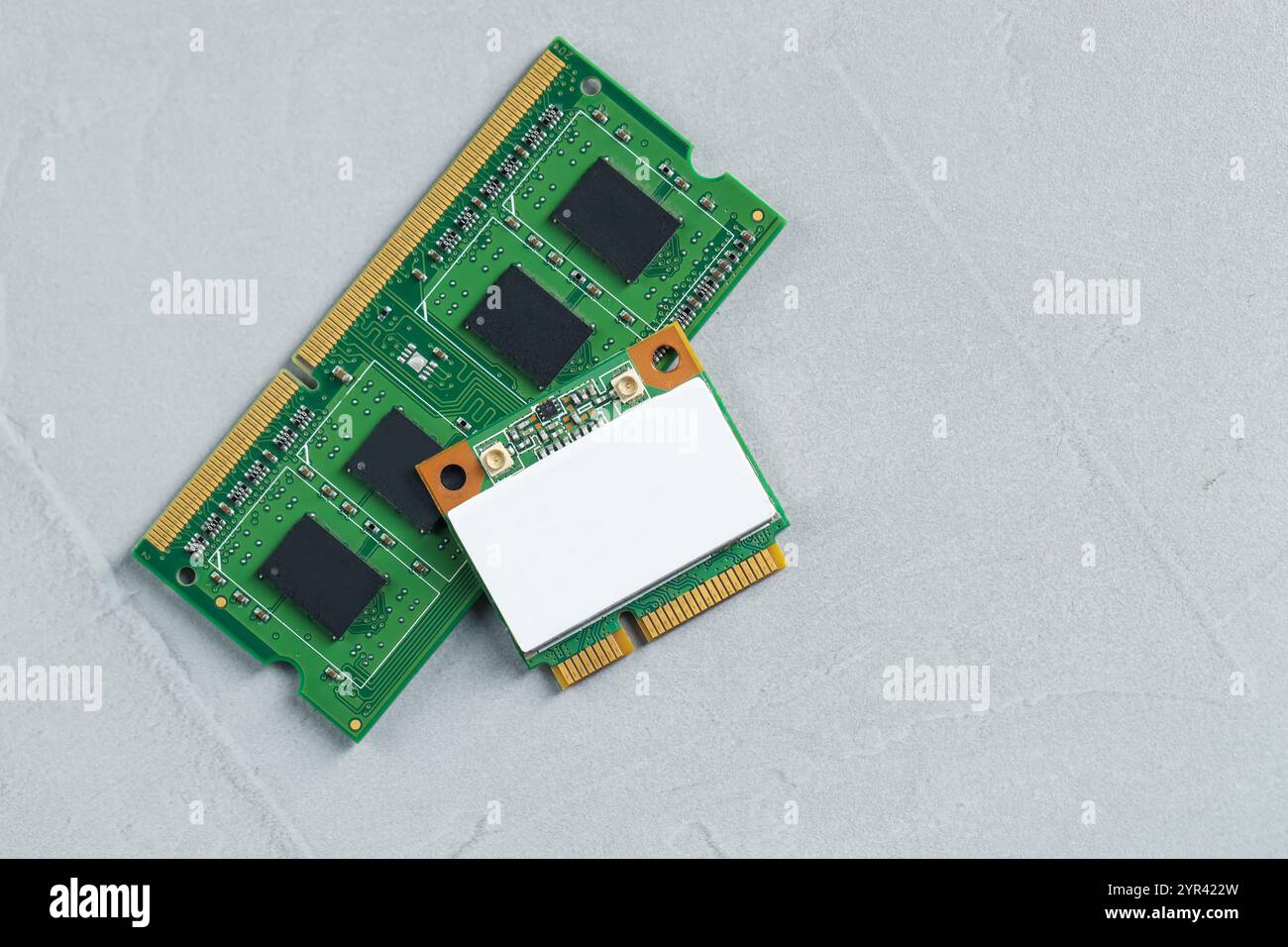 Wi-Fi card and RAM chip on grey table, top view. Space for text Stock ...