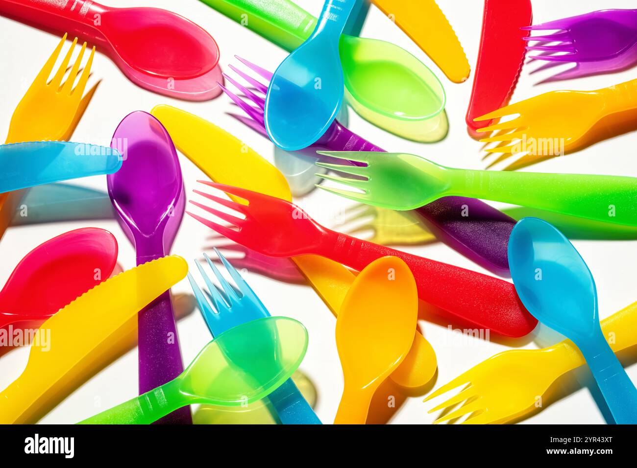 Colorful plastic cutlery in a wild mess Stock Photo - Alamy