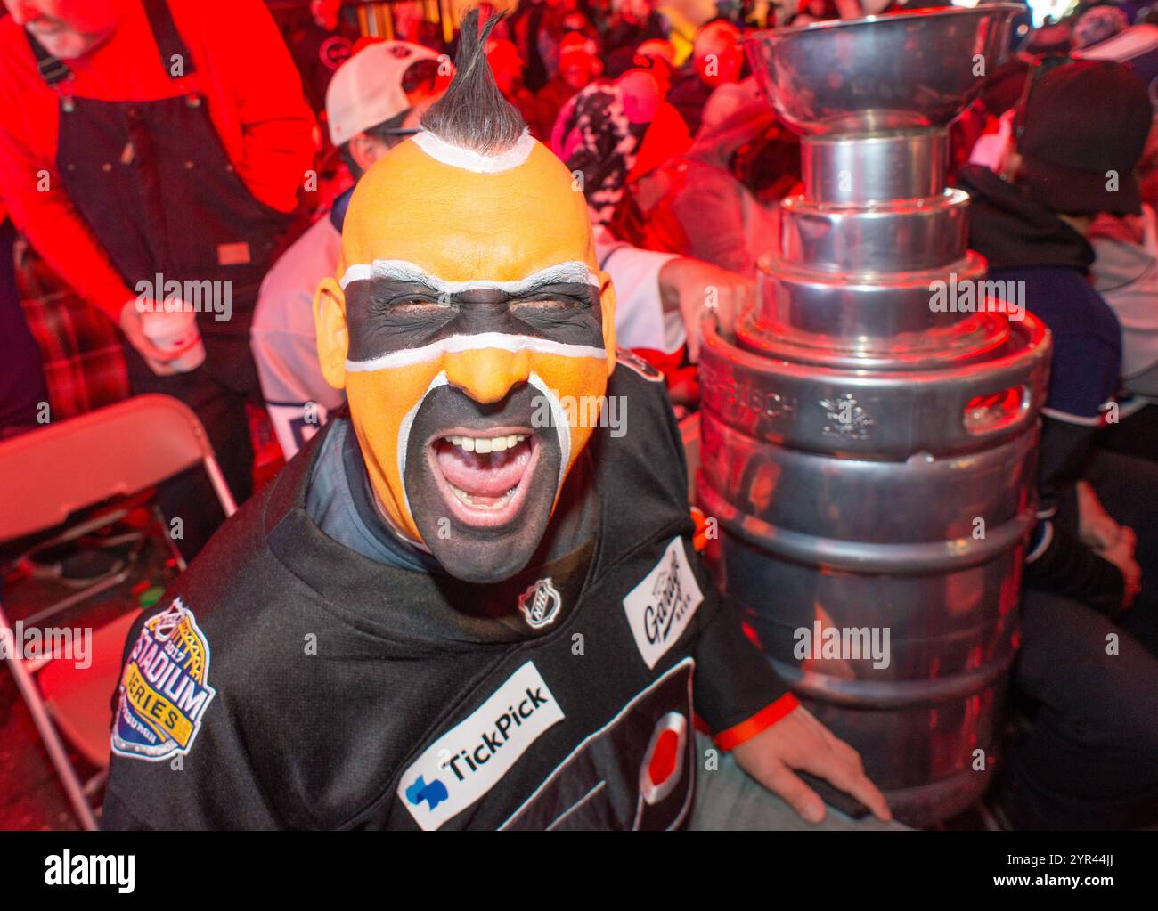 Volunteer Jamie Pagliei cheers along with a fiaux Stanley Cup during ...