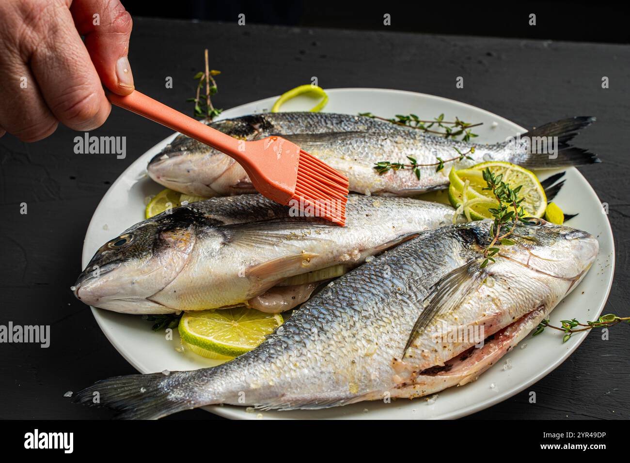 Recipe for dorado fish. Raw, fresh fish with coarse salt, leeks and ...