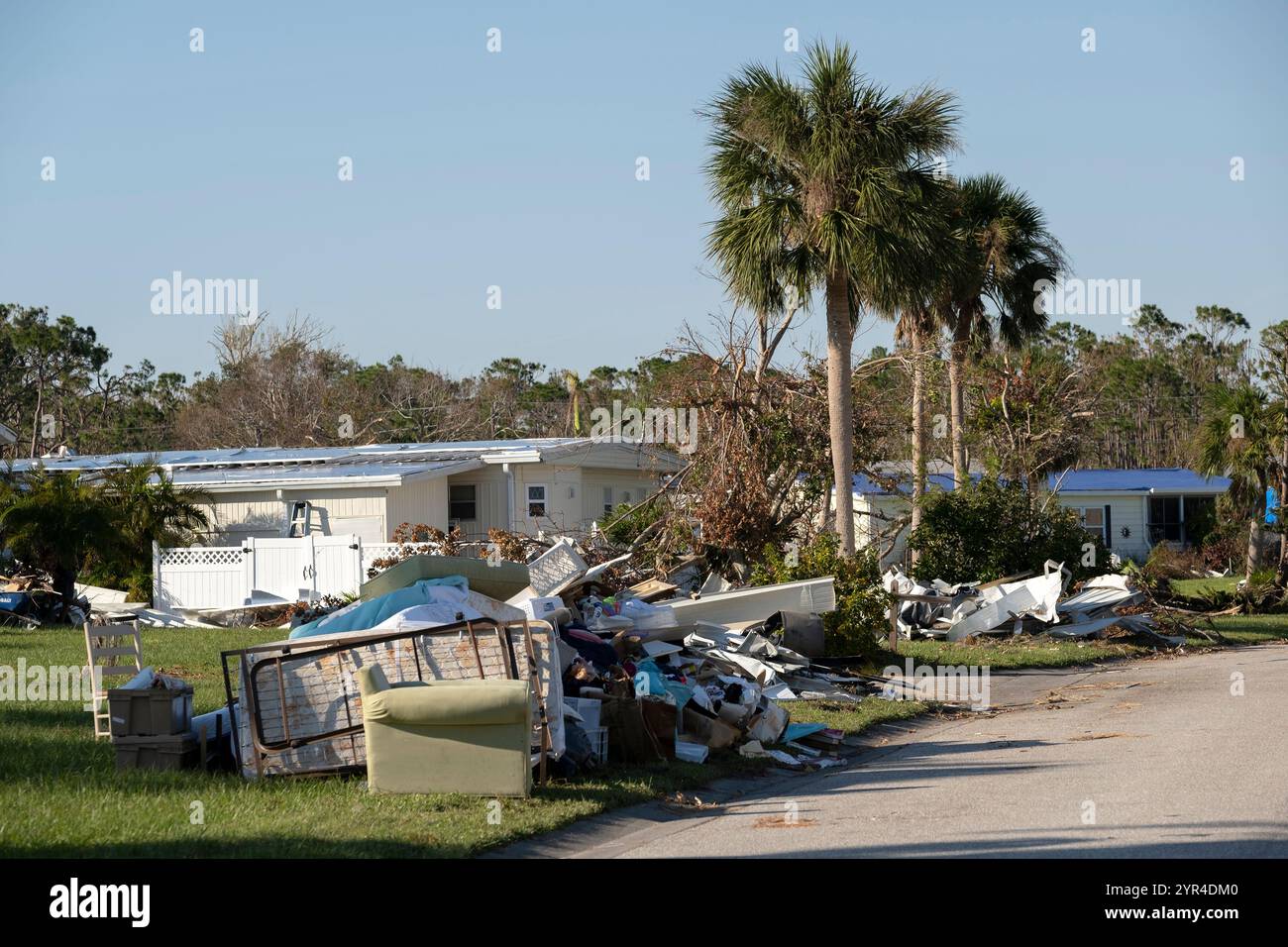 Scrap metal disposed in heaps on street side after hurricane severely ...