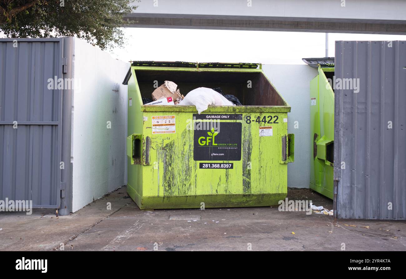 Houston, Texas USA 11-24-2024: Dumpster in fenced enclosure Green For ...