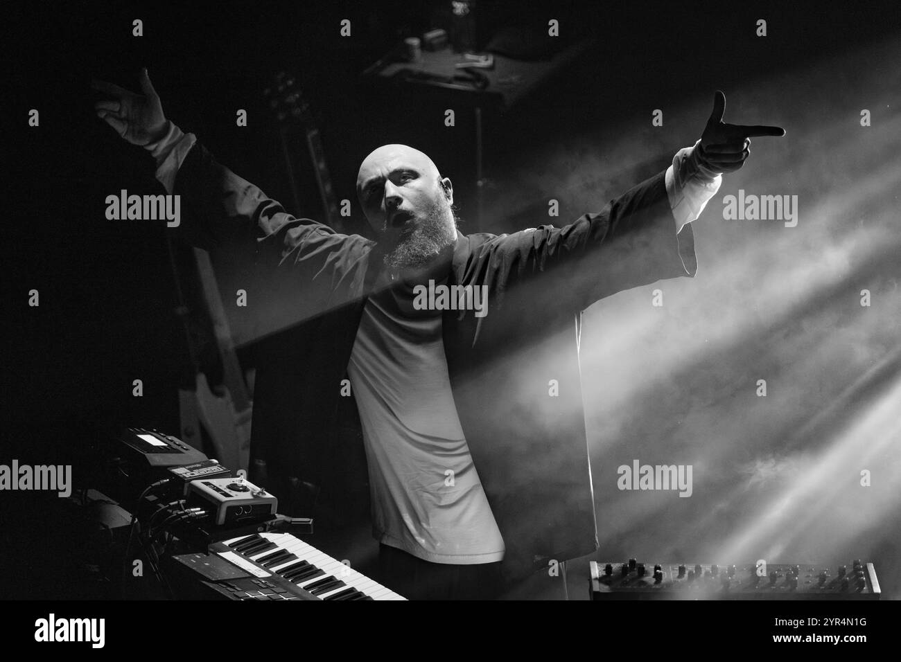 Roman Komogortsev playing the keyboards and raising his arms in the air ...