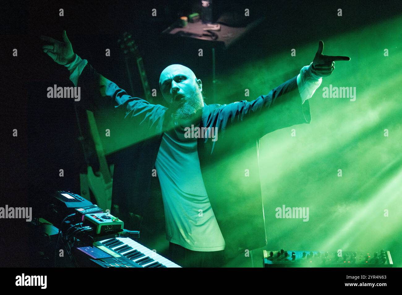 Roman Komogortsev playing the keyboards and raising his arms in the air ...