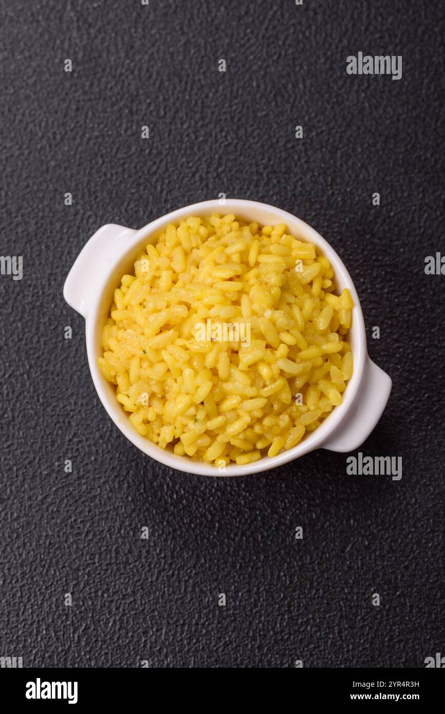 Italian arborio risotto rice with salt, spices and herbs on a dark ...