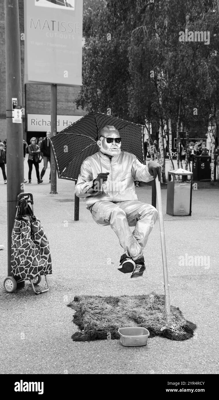 LONDON, ENGLAND, UK - MAY 3, 2014: Unidentified floating man in silver ...