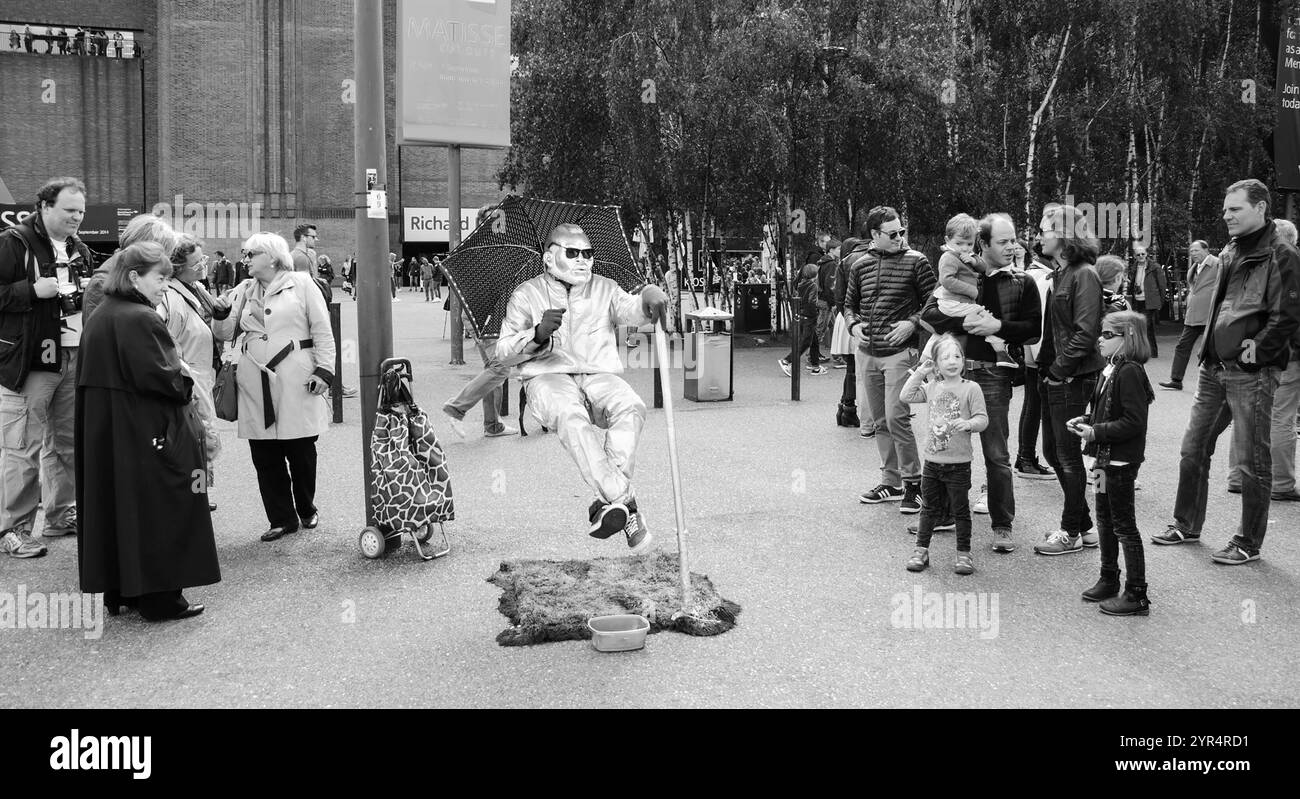 LONDON, ENGLAND, UK - MAY 3, 2014: Unidentified floating man in silver ...