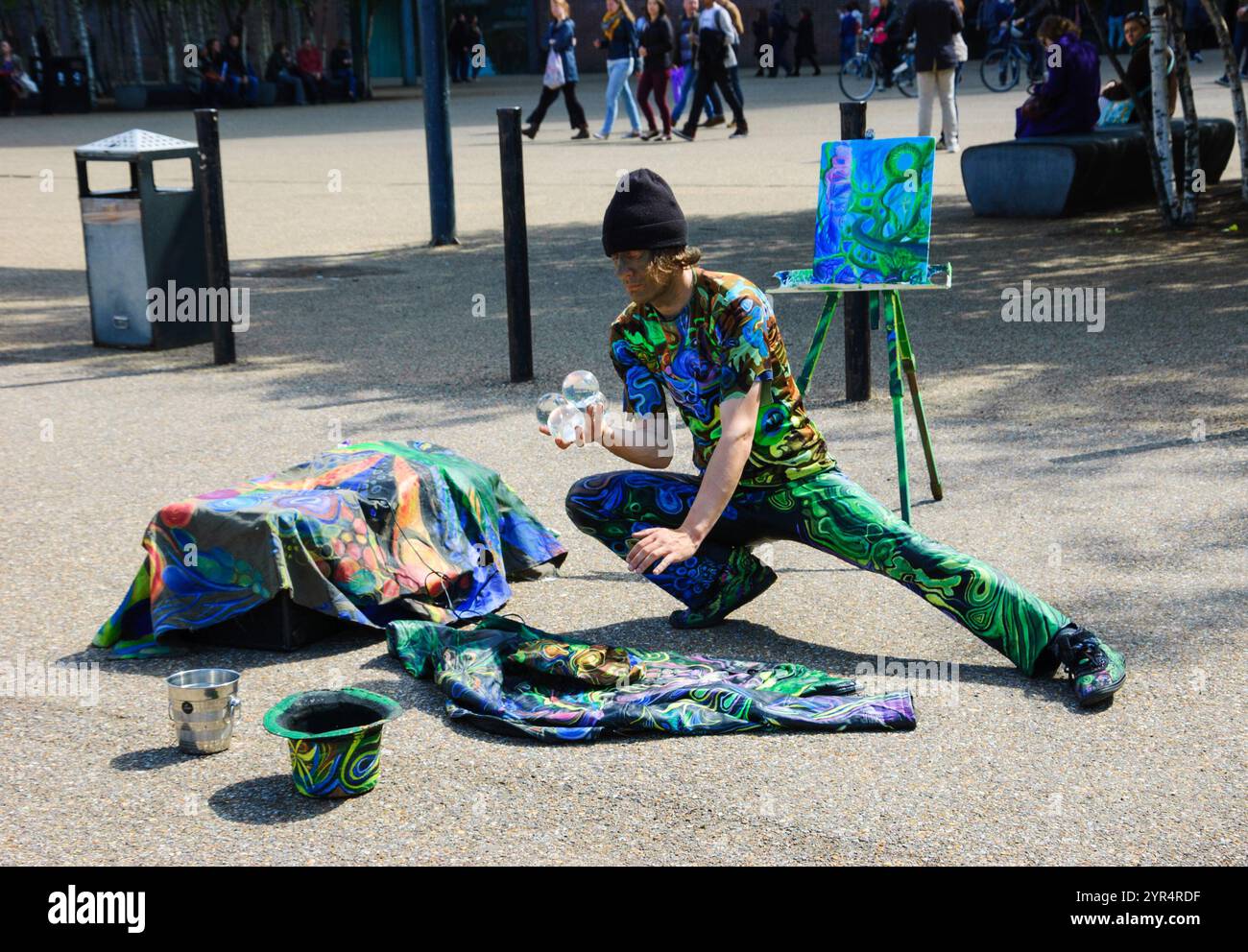 LONDON, ENGLAND, UK - MAY 3, 2014: Unidentified young juggler with four ...