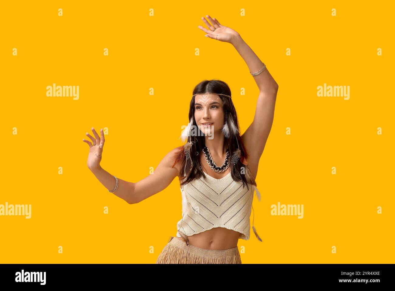 Beautiful female shaman on yellow background Stock Photo - Alamy