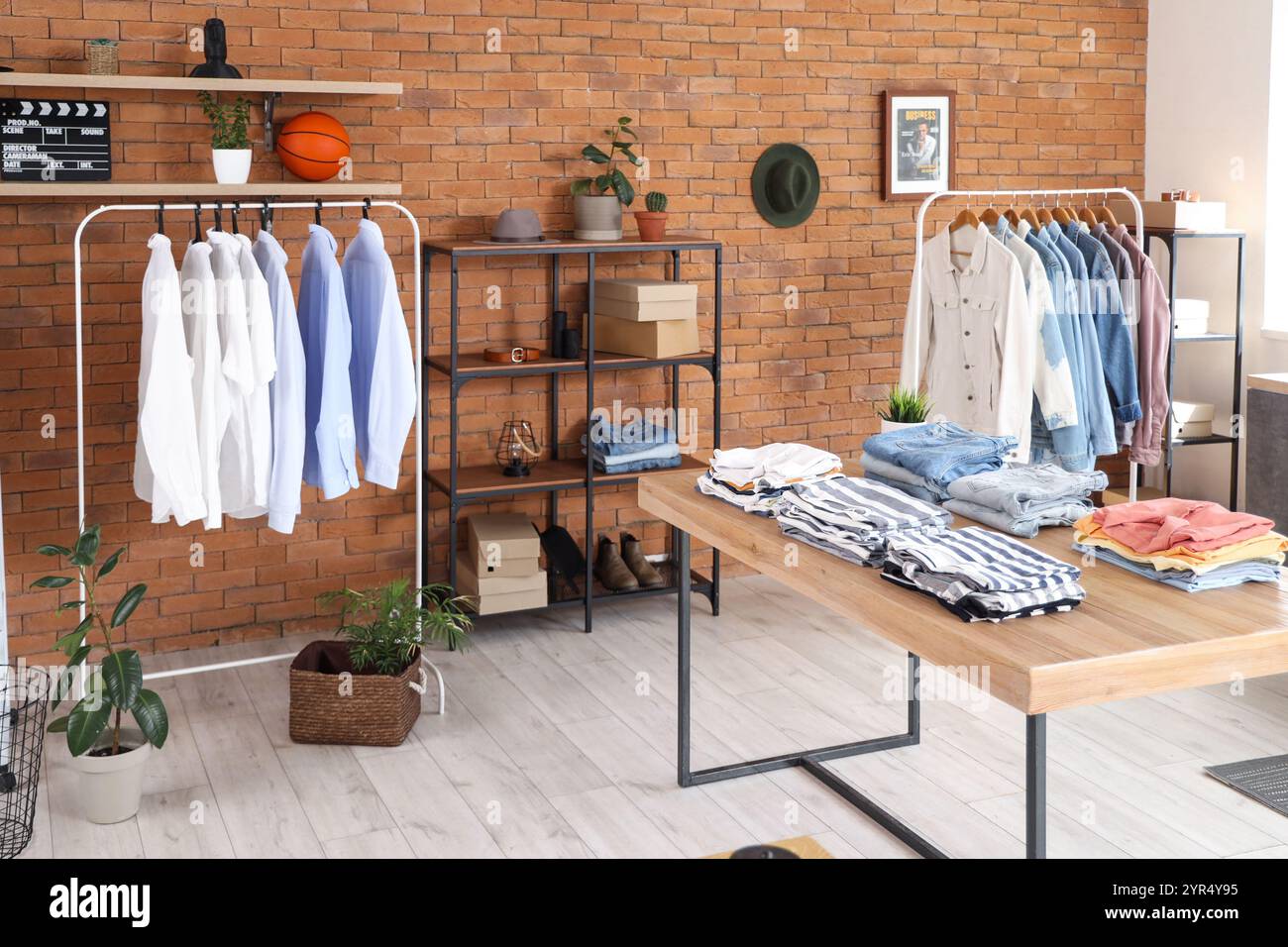 Interior of men's clothing store with racks, shelf unit and table Stock ...