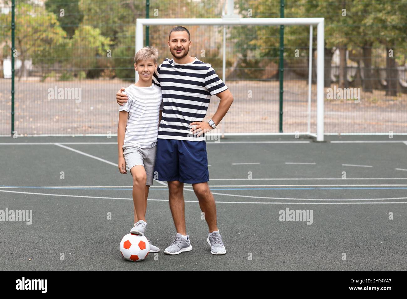 Father and his son with soccer ball outdoors Stock Photo - Alamy