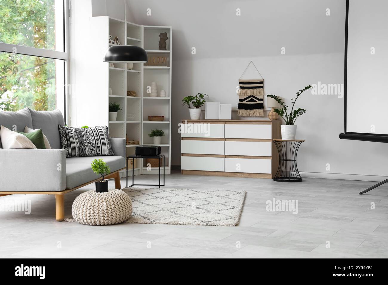 Interior of light living room with sofa and projector screen Stock ...